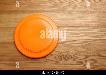 Orange plastic frisbee disk on light blue background, top view Stock ...