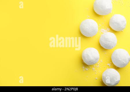 Snowballs on yellow background, flat lay. Space for text Stock Photo ...