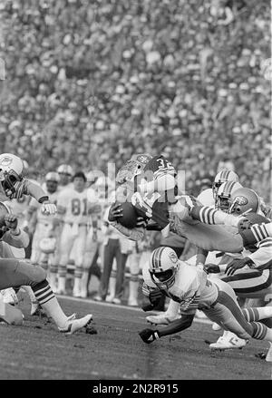 San Francisco 49ers' Carl Monroe scrambles to evade a tackle by ...