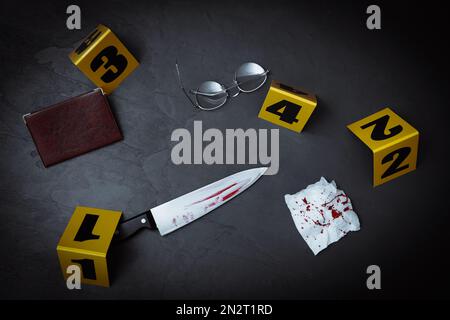 Flat lay composition with evidences and crime scene markers on black ...