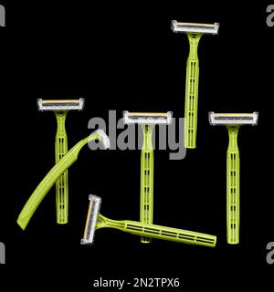 Image of several disposable razors in green on a black background Stock ...