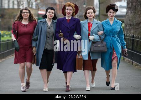 Models dressed in 1940s style clothing pose for pictures outside the ...