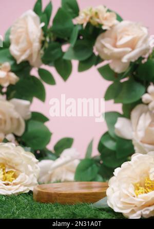 wood podium beige rose flowers on pink pastel background with space ...