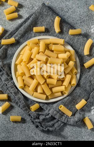 Italian pasta raw Maccheroni for cooking served vegetables Stock Photo ...