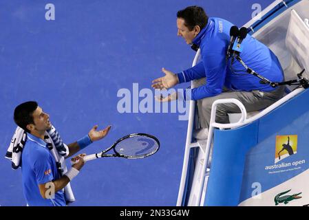 Novak Djokovic (left) talks with chair umpire Richard Haigh after a ...
