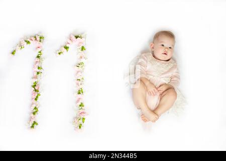 11-month-old baby girl. Baby milestone eleven months. Eleven-month-old ...