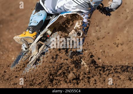 Flying debris from a motocross in dirt track Stock Photo - Alamy