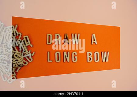 DRAW A LONG BOW in wooden English language capital letters spilling ...