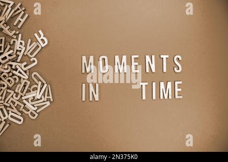MOMENTS IN TIME in wooden English words language capital letters ...