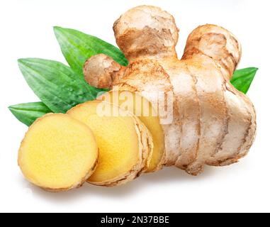 Ginger root and round slices of ginger root on green leaves isolated on ...
