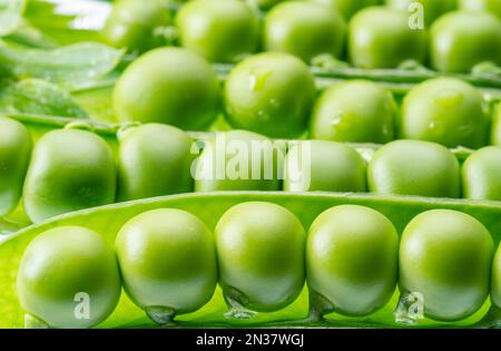 Perfect green peas in pea pods close up. Food background Stock Photo ...