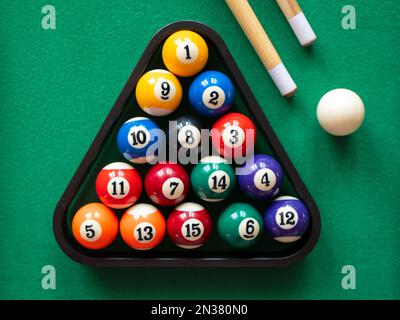 Billiard ball and cue on green table Stock Photo - Alamy