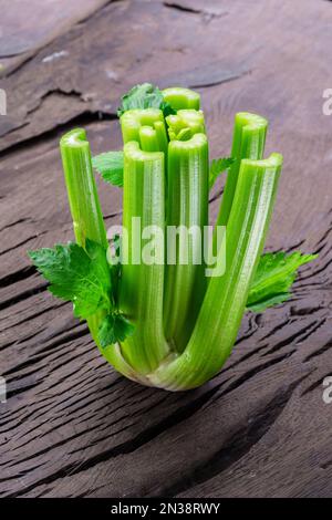 Pile of celery ribs on green wooden table. Healthy food background ...