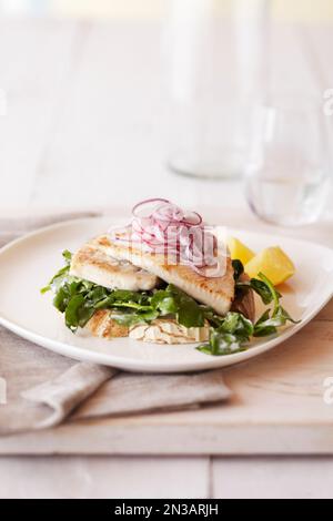 Open sandwich with red fish trout and salad on a wooden board. Concept ...