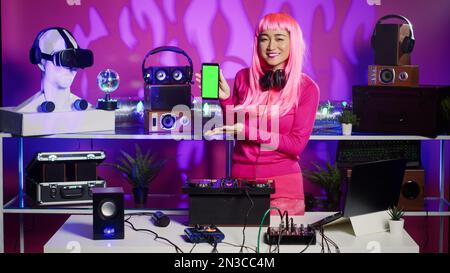 Dj artist presenting green screen mock up mobile phone with isolated ...