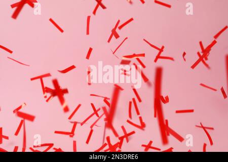 Shiny red confetti falling down on light blue background Stock Photo ...