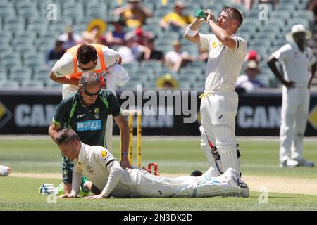 Australia's Michael Clarke stretches after a shot, during day one of ...