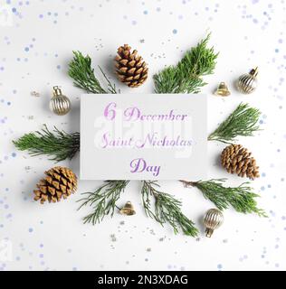 Composition of saint nicholas day text over santa claus holding car ...