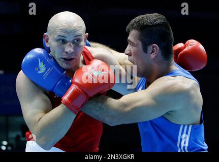 Kazakhstan's Ivan Dychko left, competes against Iran's Jasem Delavari ...