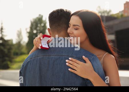 Man with engagement ring making proposal to his girlfriend against ...