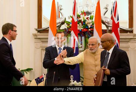 Prime Minister Tony Abbott uses a 3D printed pen during a visit to the ...