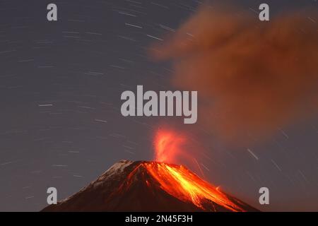 The Tungurahua volcano throws ash and stones during an eruption seen ...