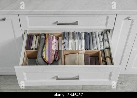 Open drawer with different textiles in kitchen, above view Stock Photo ...