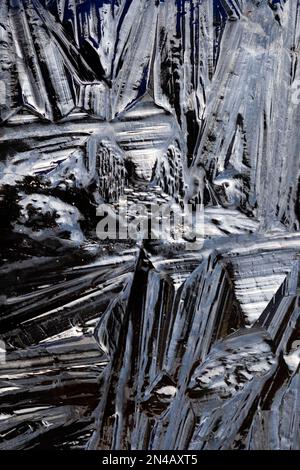Shards of frozen water ice form patterns look black view from above ...