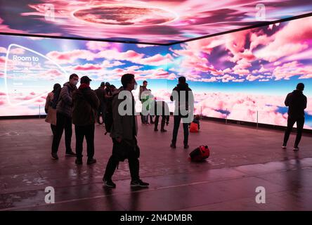 The now building. Members of the public look at huge screens ...