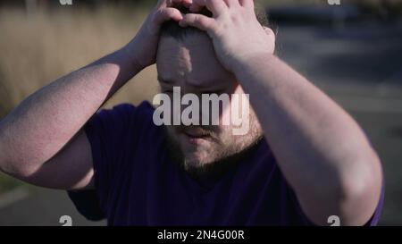 Suffering overweight man feeling headache rubbing eyes standing on ...