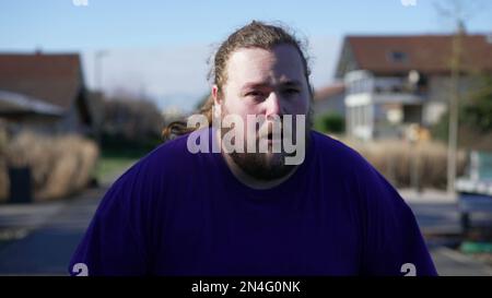 One young fat man having chest pain. Overweight person with panic ...
