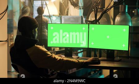 Mysterious spy planning security breach with virus, hacking computer server and breaking ...