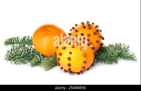 Pomander balls, Christmas tree branches and cinnamon on orange ...