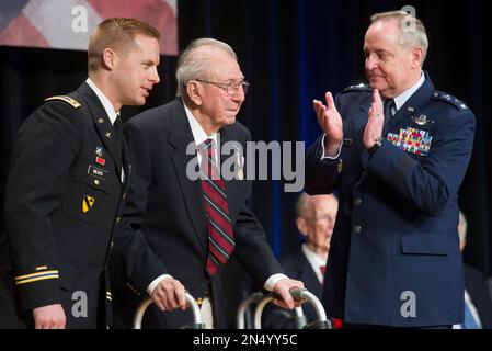 Retired Air Force Col. (Dr.) James Ruffer stands in front of a Navy F9F ...