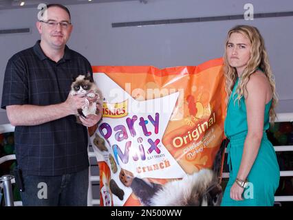 Meme starter Bryan Bundesen and owner Tabatha Bundesen are seen with Grumpy Cat as Friskies ...