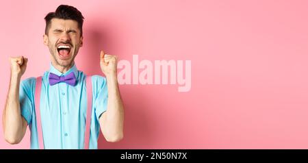 Relieved man shouting from happiness and joy, scream yes with closed ...