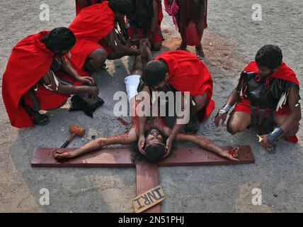 An Indian Christian devotee enacts the crucifixion of Jesus Christ to ...