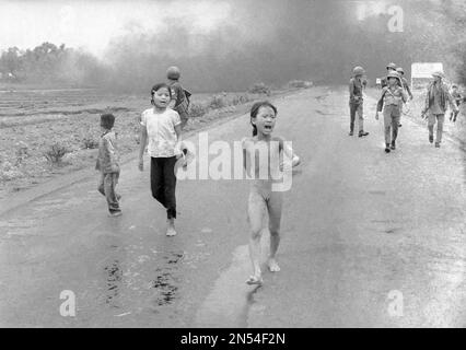 South Vietnamese forces follow after terrified children, including 9-year-old Kim Phuc, center ...