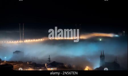 Cityscape night view. Fog over the city Stock Photo - Alamy