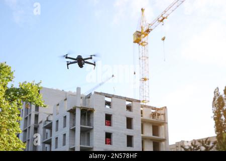 Modern drone flying at building site. Aerial survey Stock Photo - Alamy