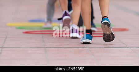 Competitive active game, children jump over obstacles Stock Photo - Alamy