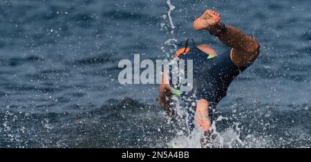 Swimmer at the start, jump flight into the ocean Stock Photo - Alamy