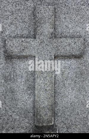 Simple vintage Christian cross standing high on a tombstone in the ...