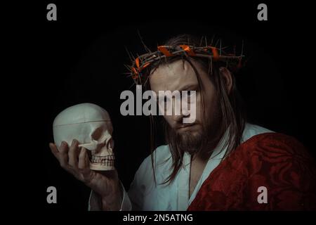 Jesus Christ with skull wearing a crown of thorns and white chiton toga ...