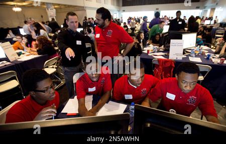 Magnetar CEO Alec Litowitz, left, checks a computer as Sullivan High ...