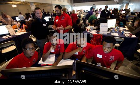Magnetar CEO Alec Litowitz, left, checks a computer as Sullivan High ...