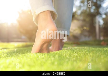 Man walking barefoot on fresh green grass, closeup Stock Photo - Alamy