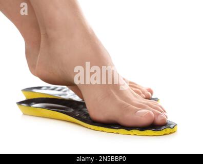 Woman fitting orthopedic insoles on white background, closeup. Foot ...