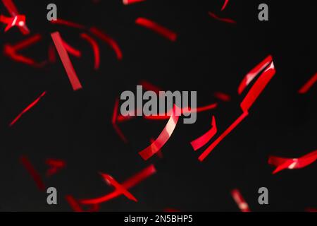 Shiny red confetti falling down on light blue background Stock Photo ...