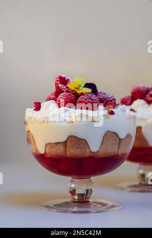 Raspberry trifle with fruit jelly, custard and cream Stock Photo - Alamy